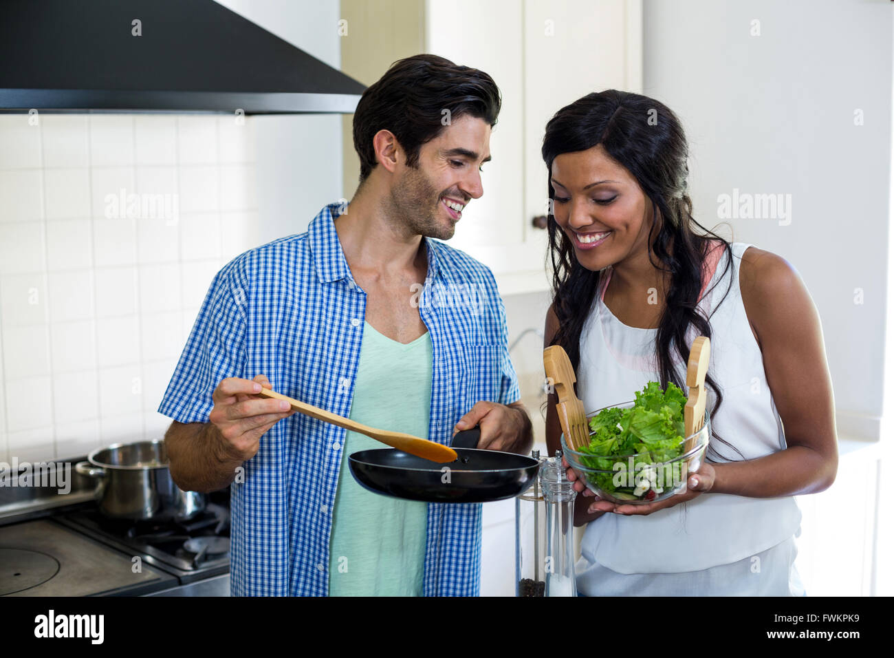 Young couple cooking food together in kitchen Stock Photo - Alamy