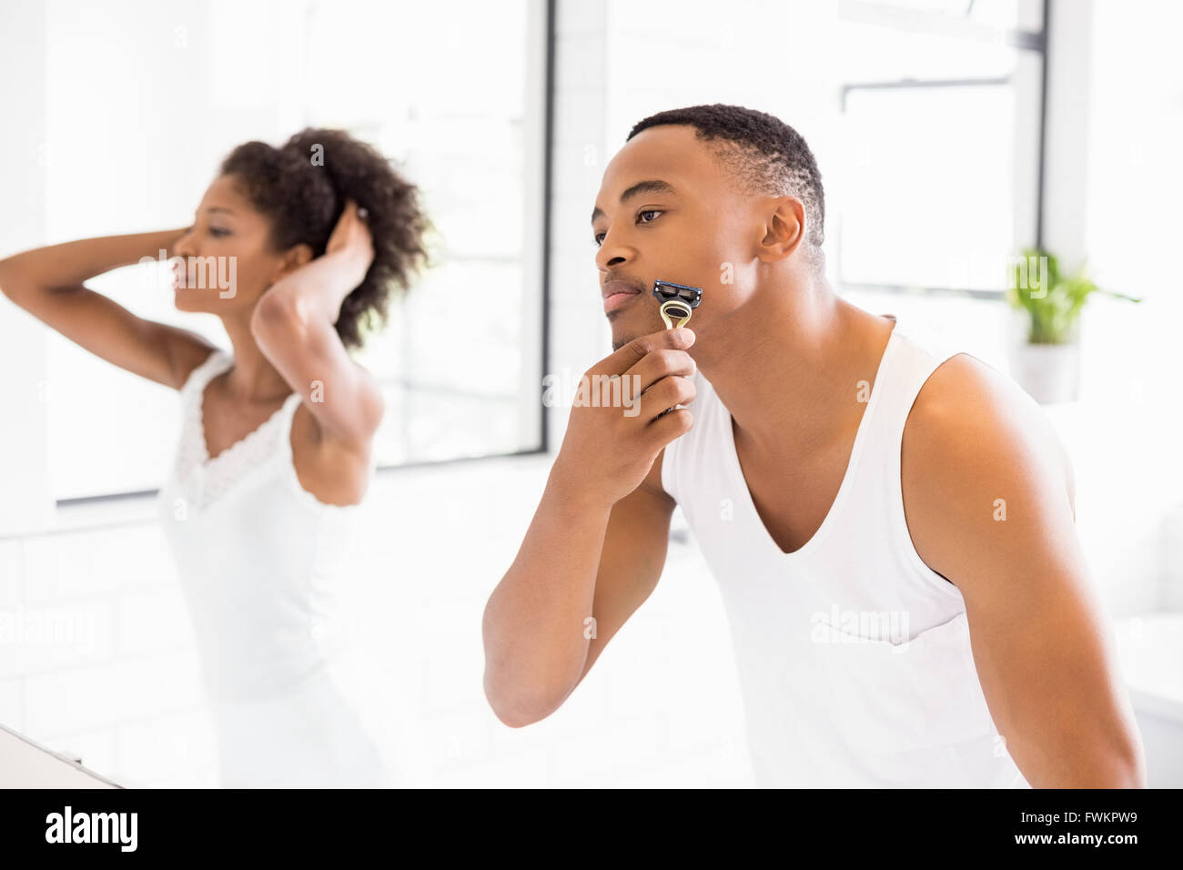 Bathroom man in the bathroom shaving with a razor hi-res stock ...