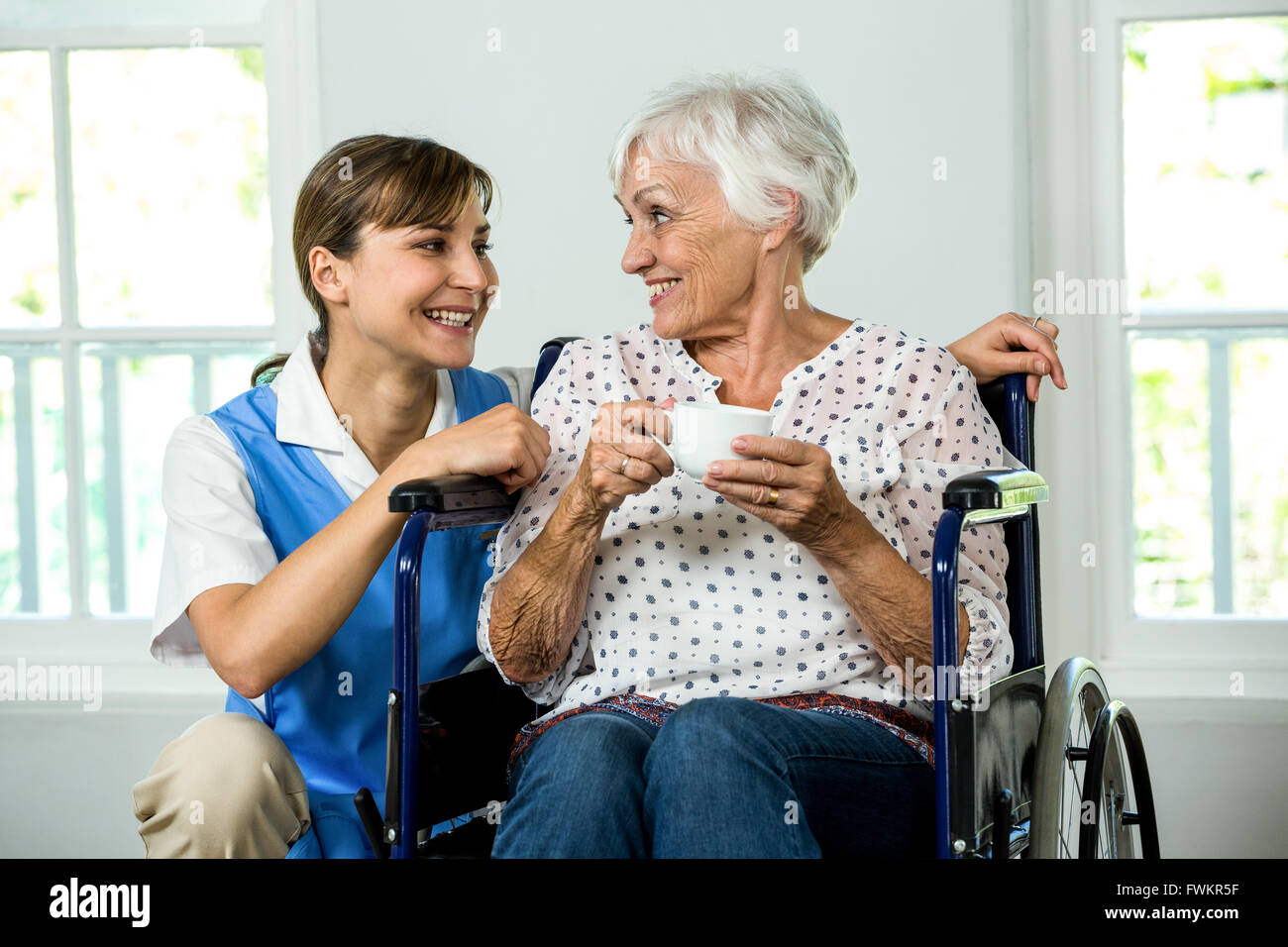 Smiling senior woman with nurse Stock Photo - Alamy