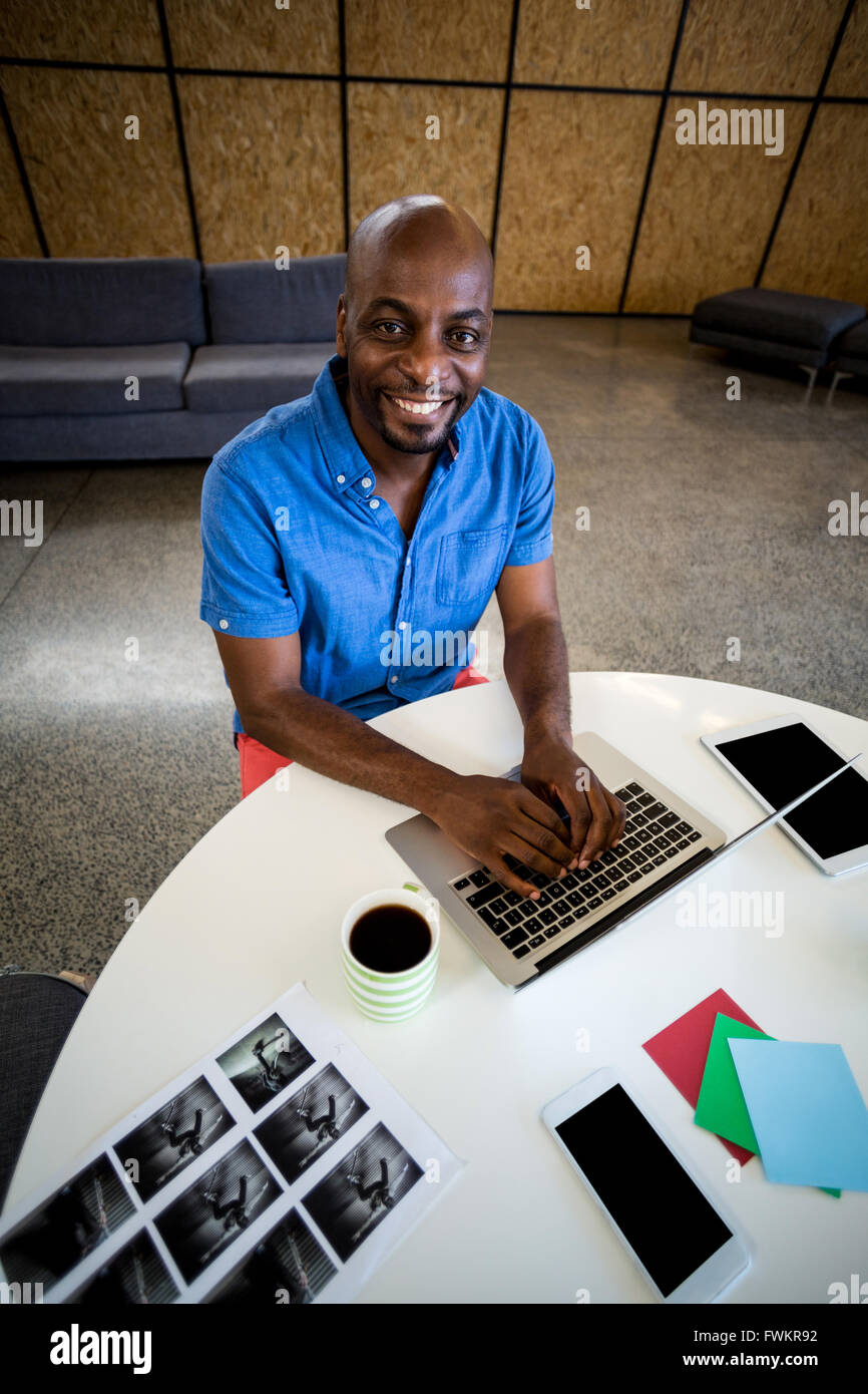 Young man working at his desk Stock Photo - Alamy