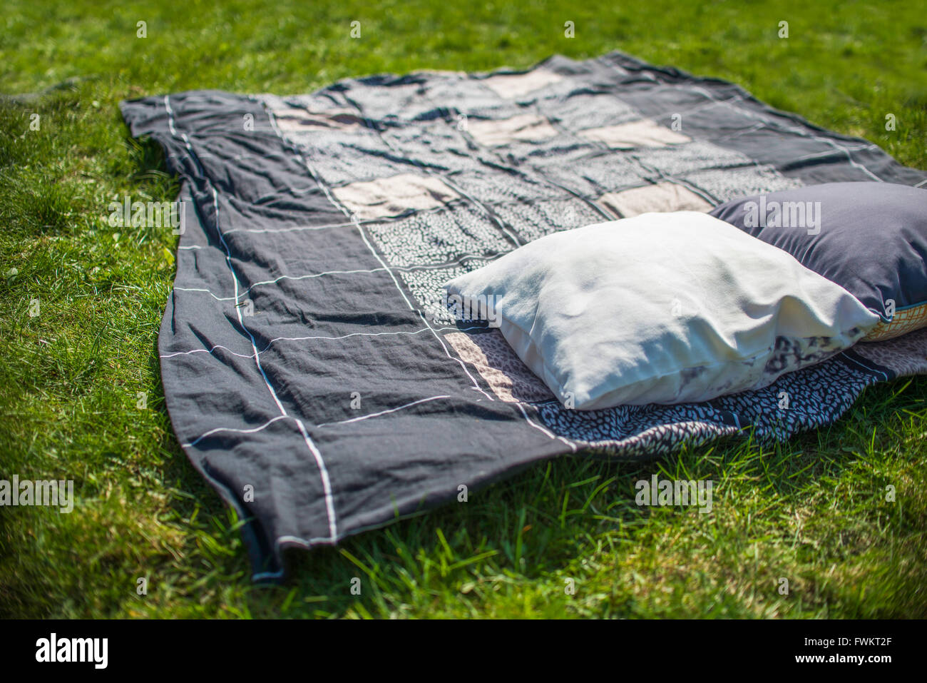 picnic blanket with pillow on the grass field Stock Photo - Alamy
