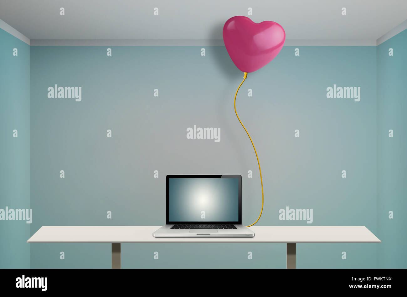 Balloon heart-shaped connected to the laptop with a network cable Stock ...