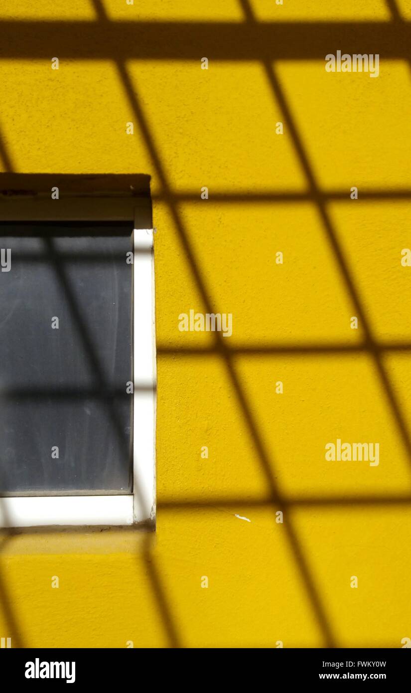 Patterned Shadow On Yellow Wall Of House Stock Photo - Alamy