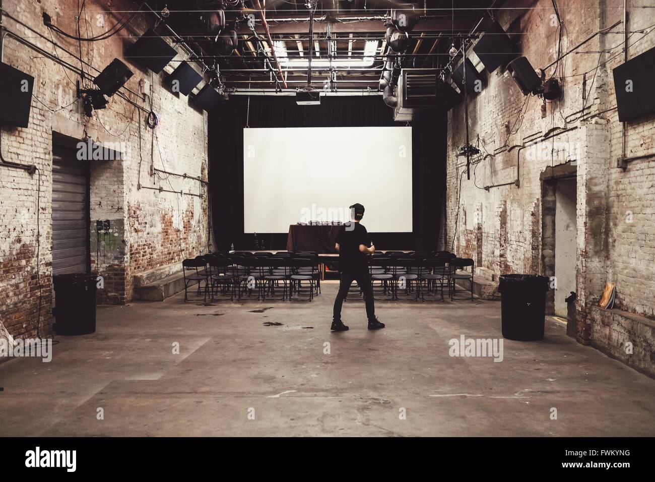 Full Length Of Man Walking Against Projection Screen In Studio Stock ...