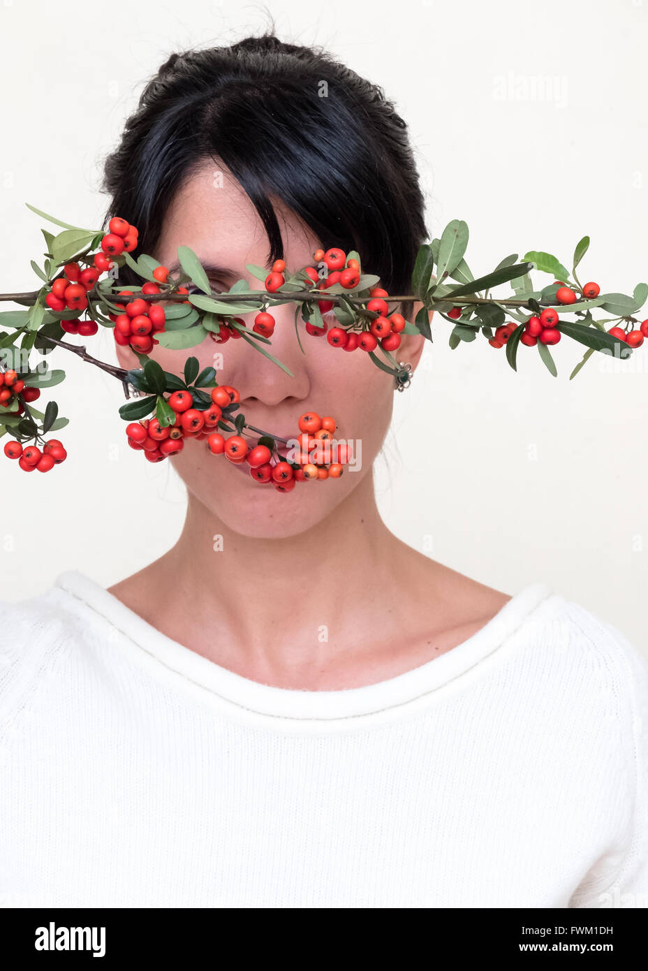 Red Berries On Woman Face Against White Background Stock Photo - Alamy