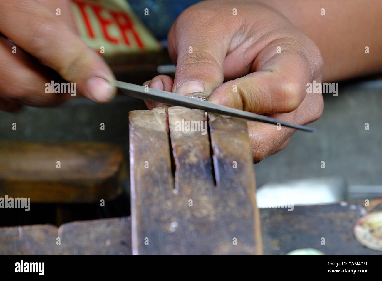Cropped Image Of Hand Cutting Wood Stock Photo - Alamy