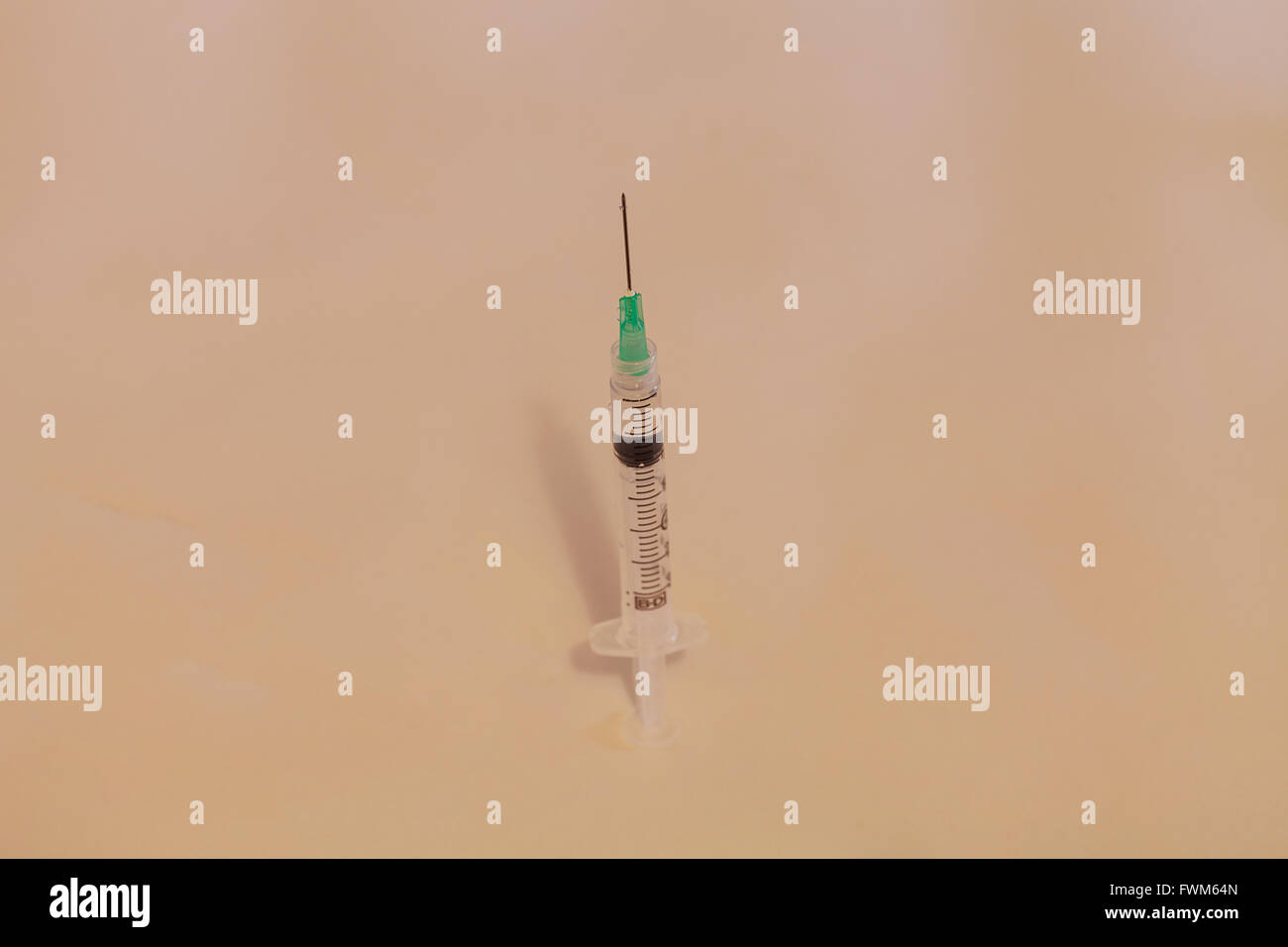 Long hypodermic needle ready for injection in a medical doctor’s office ...