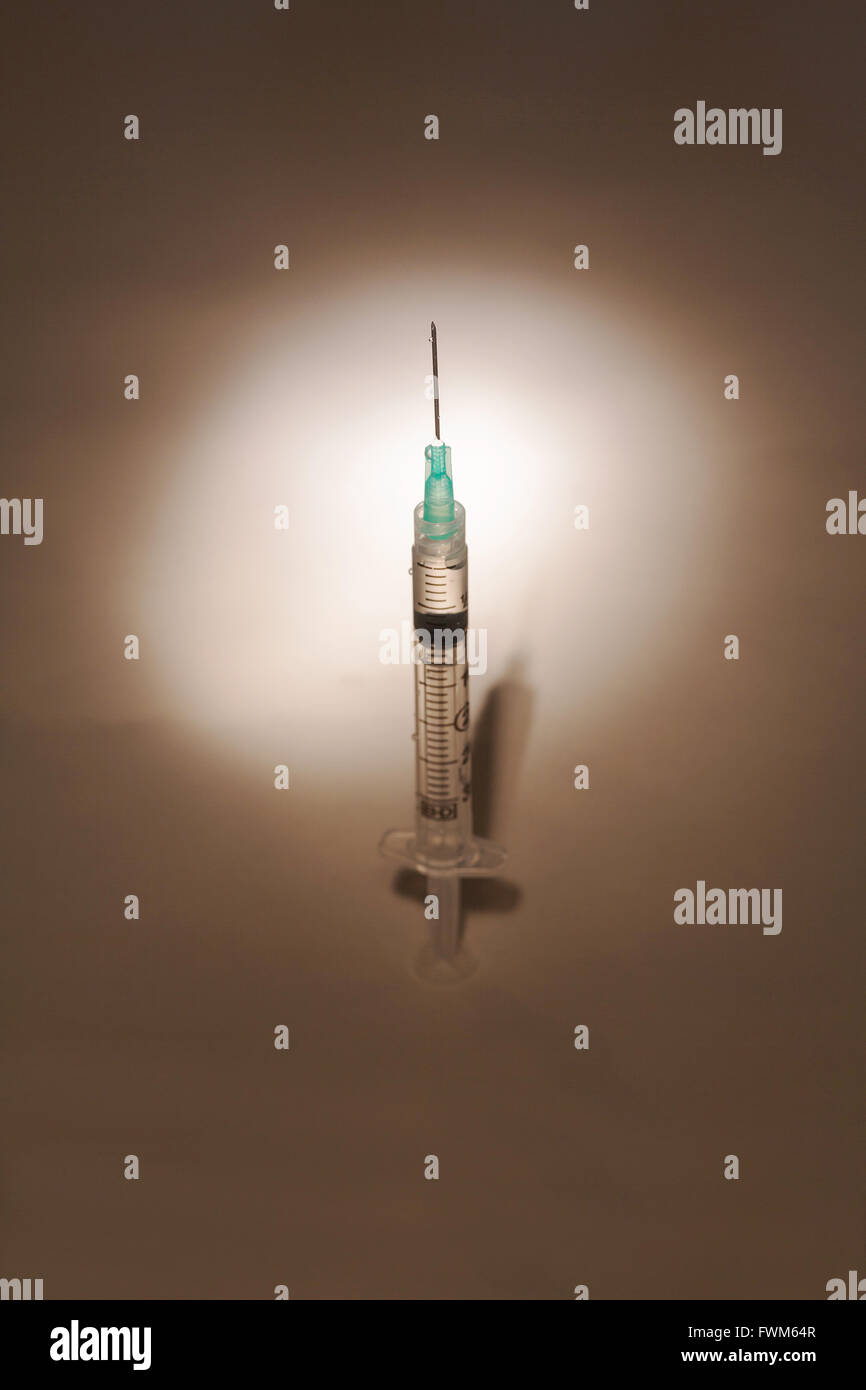 Long hypodermic needle ready for injection in a medical doctor’s office ...