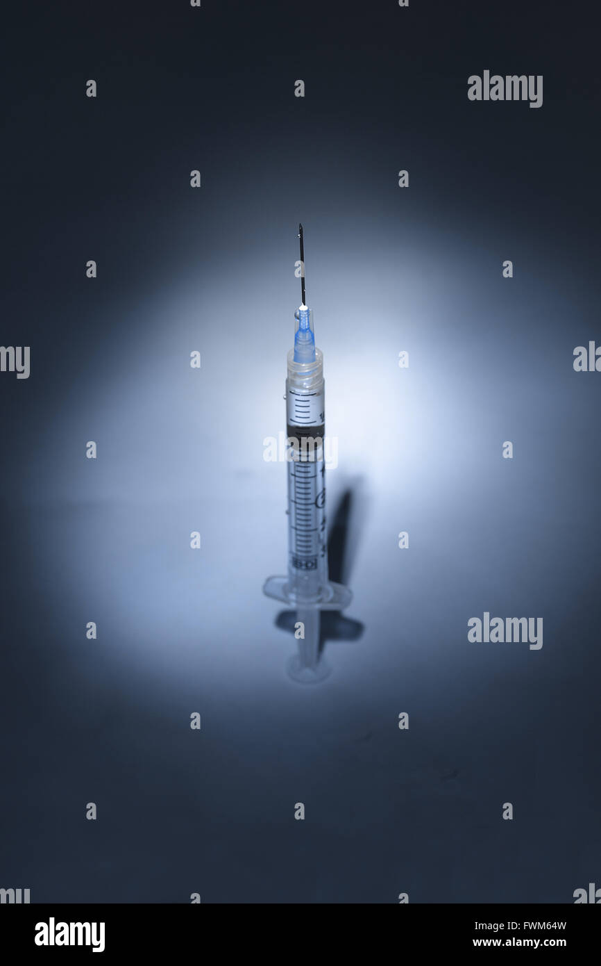 Long hypodermic needle ready for injection in a medical doctor’s office ...