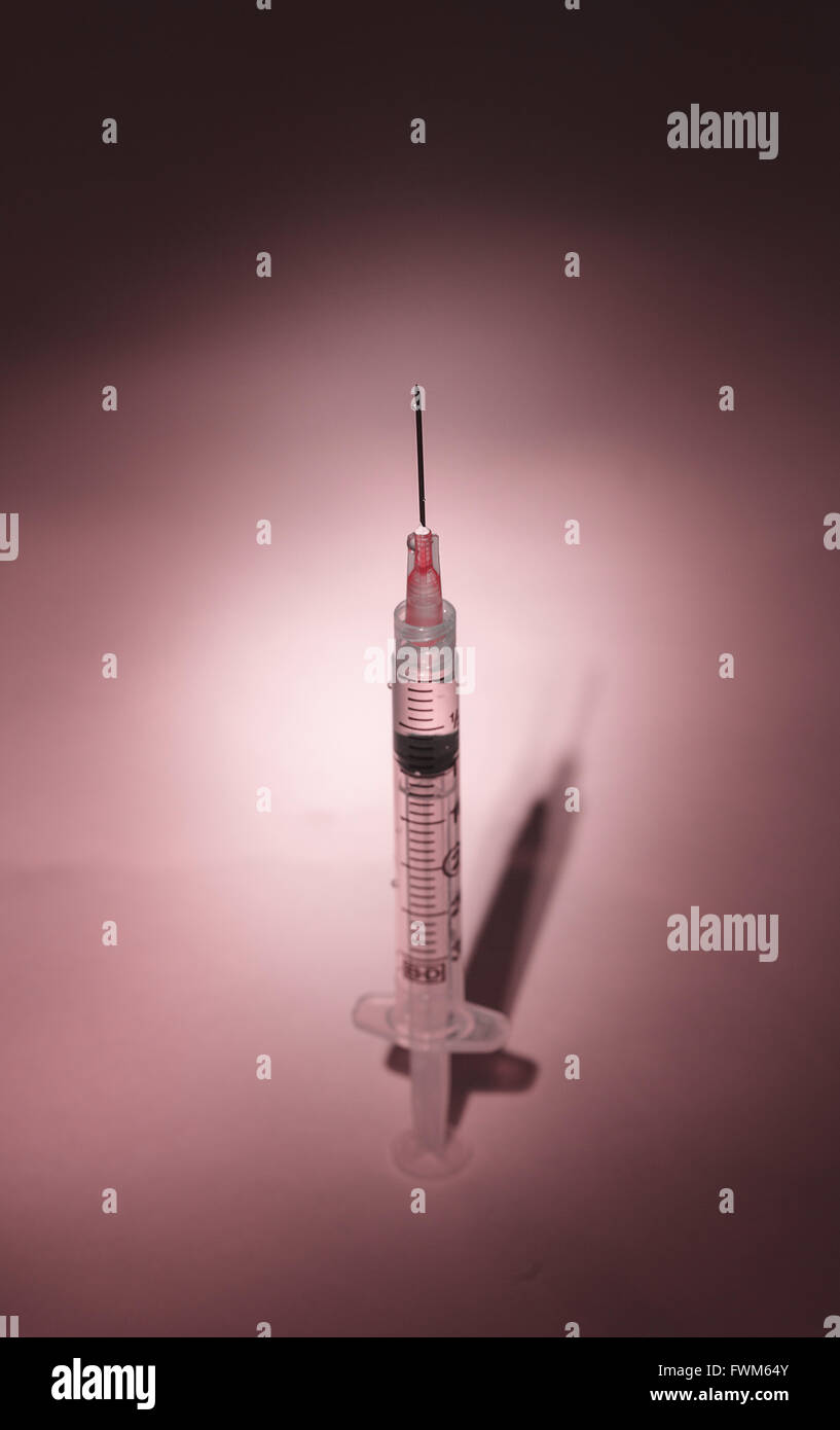 Long hypodermic needle ready for injection in a medical doctor’s office ...