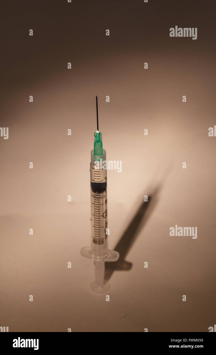 Long hypodermic needle ready for injection in a medical doctor’s office ...