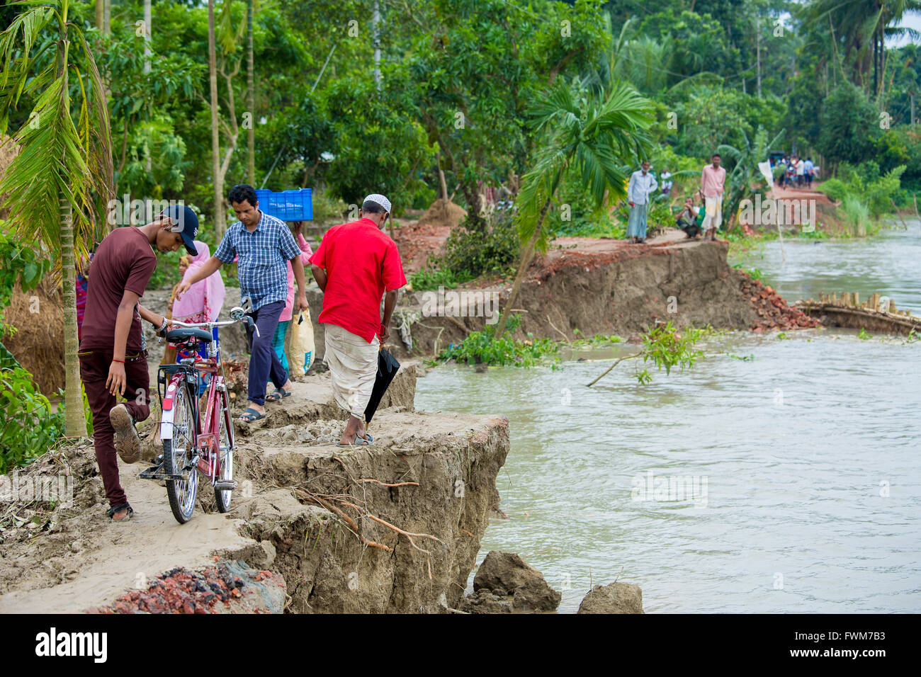 Some people walking by his home at Char areas, Borishal, Bangladesh ...