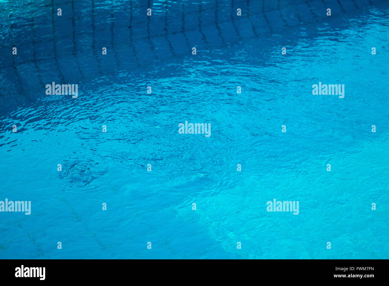 Hotel swimming pool with sunny reflections Stock Photo - Alamy