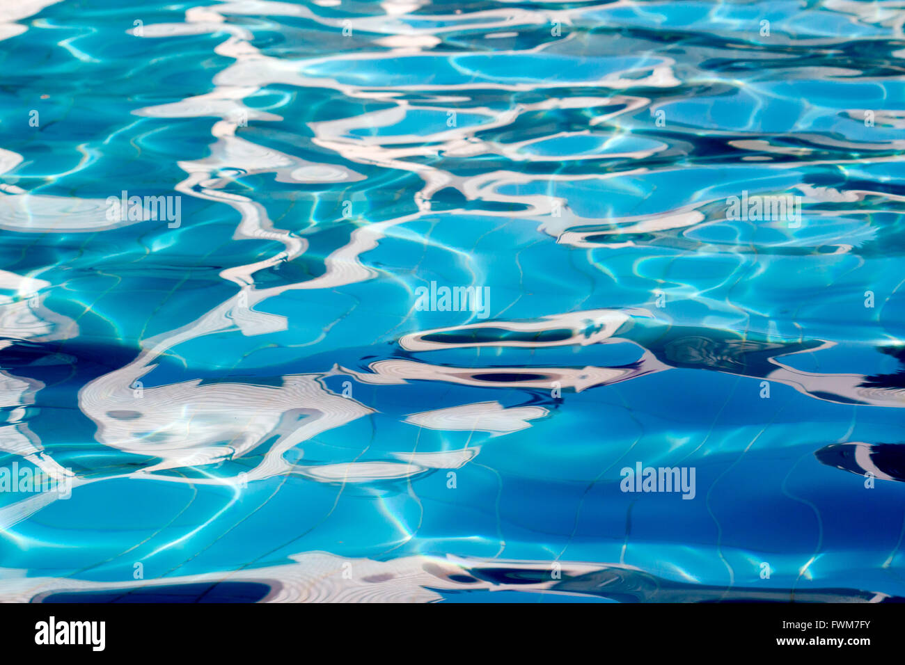 Hotel swimming pool with sunny reflections Stock Photo - Alamy