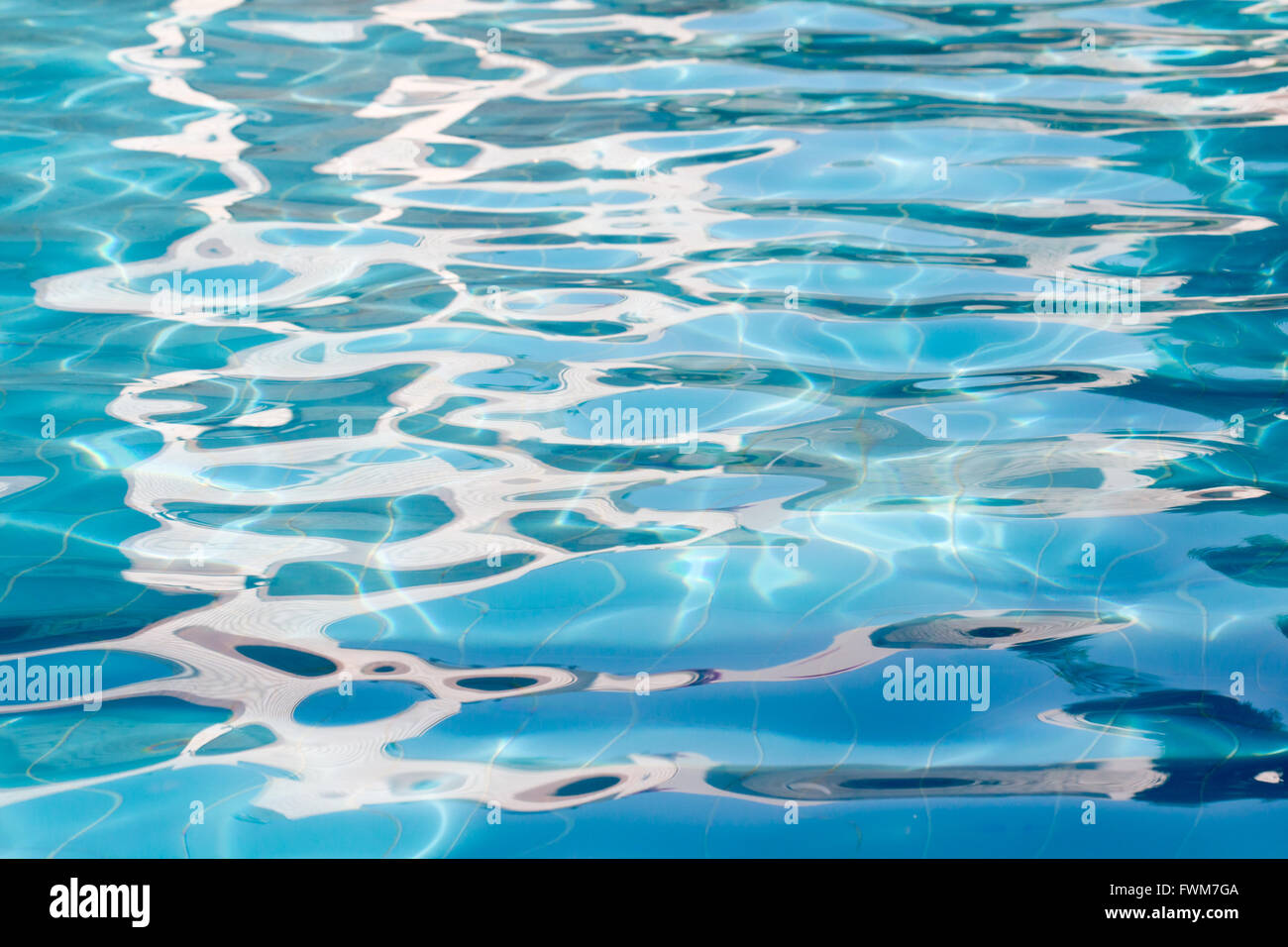 Hotel swimming pool with sunny reflections Stock Photo - Alamy