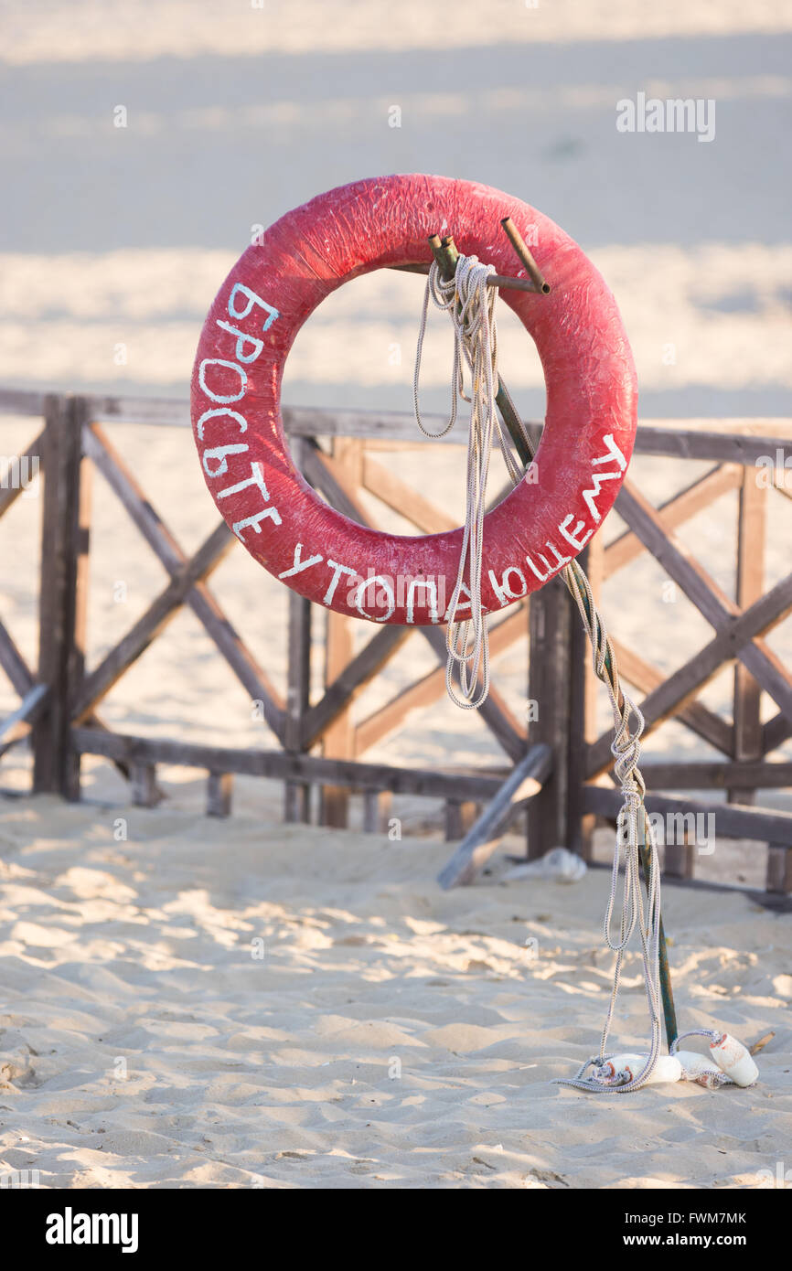 Lifebuoy throw a drowning man with a sign hanging on a rusty metal ...