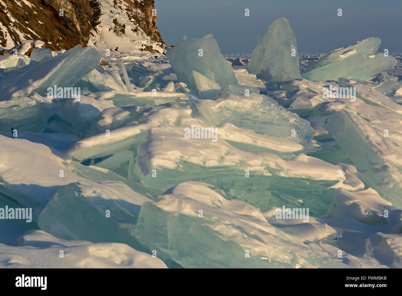 Clumps of blue ice on the snow Stock Photo - Alamy