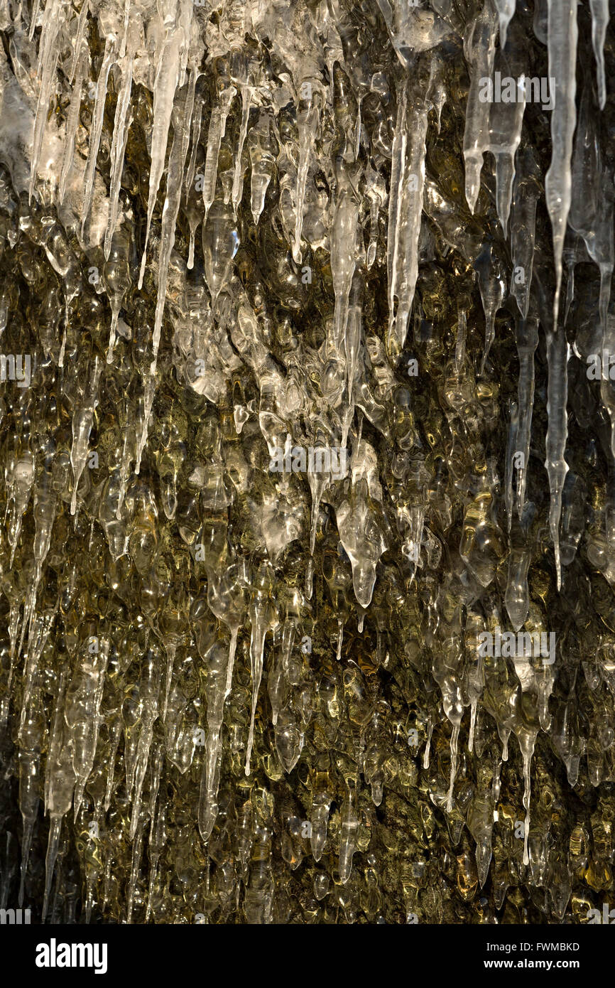 Huge icicles on rocks Stock Photo - Alamy