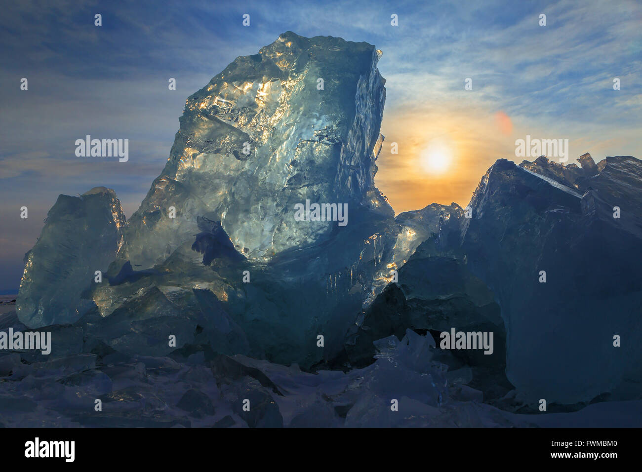 Transparent ice on sunset sky background Stock Photo - Alamy