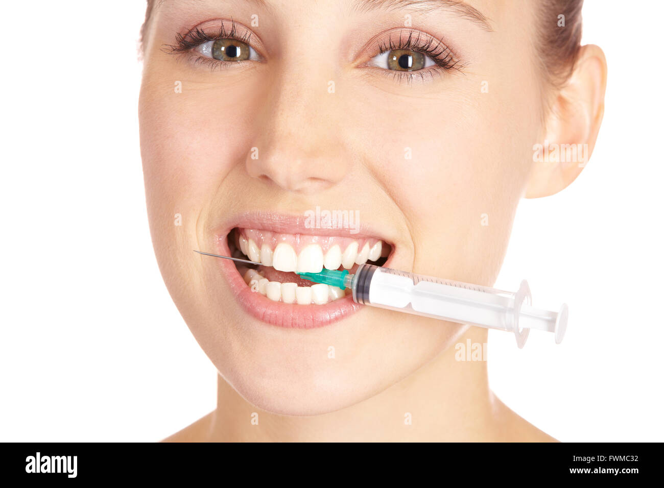 Happy attractive woman biting on syringe with needle Stock Photo - Alamy