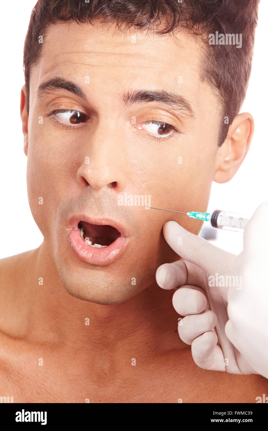 Attractive man is afraid of a needle and syringe Stock Photo - Alamy