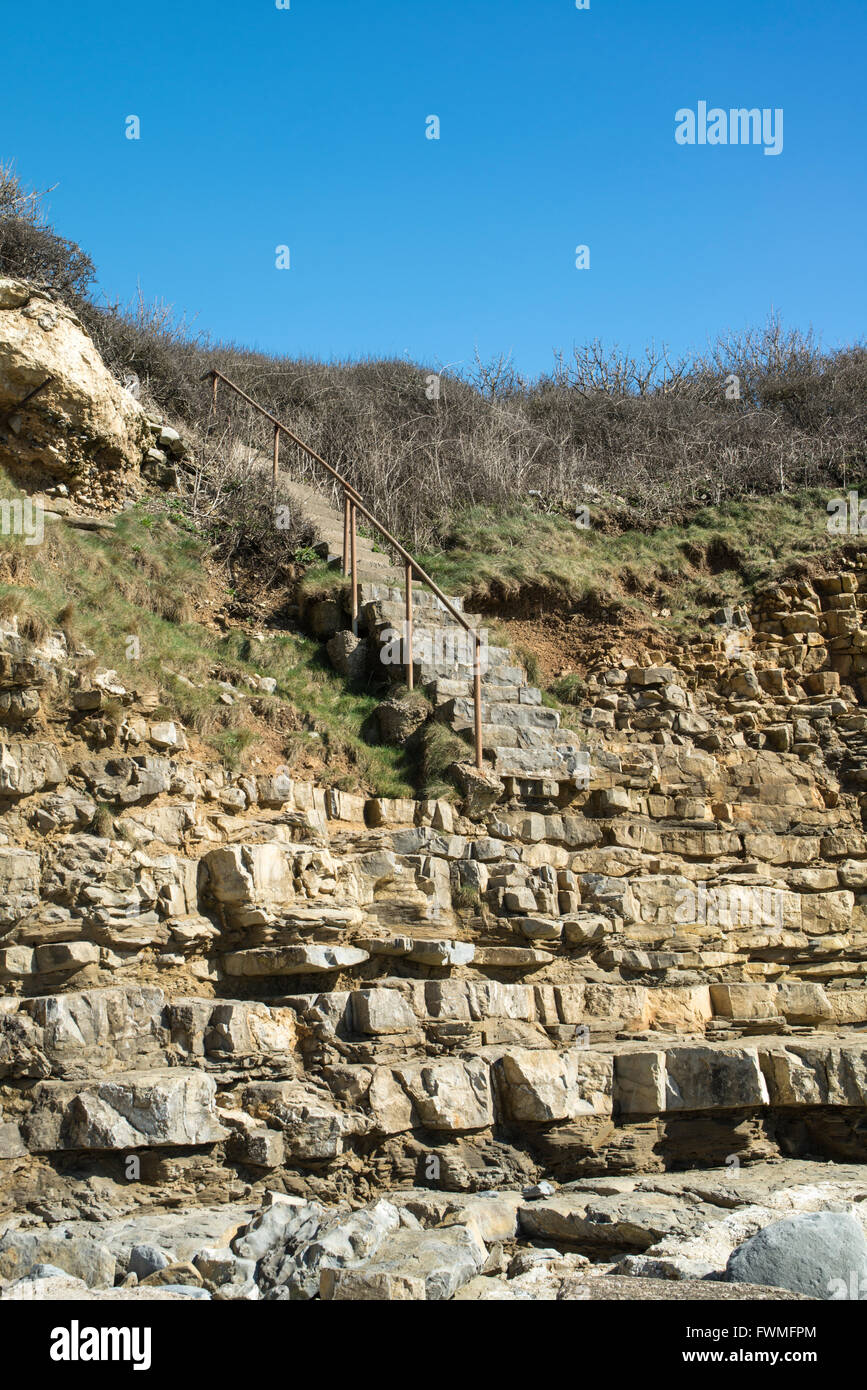 Coastal erosion leaves the steps stranded halfway up the cliff Stock ...