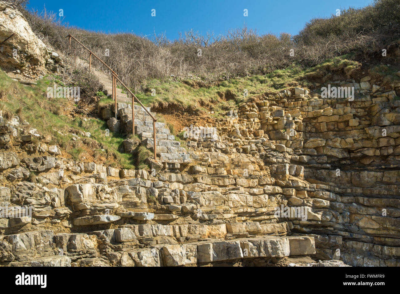 Coastal erosion leaves the steps stranded halfway up the cliff Stock ...