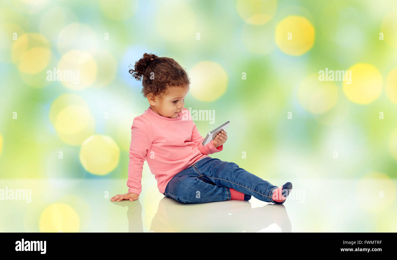 smiling little baby girl playing with smartphone Stock Photo - Alamy
