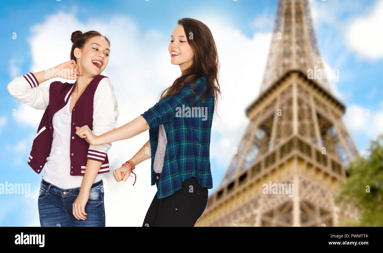 happy teenage girls dancing over eiffel tower Stock Photo - Alamy