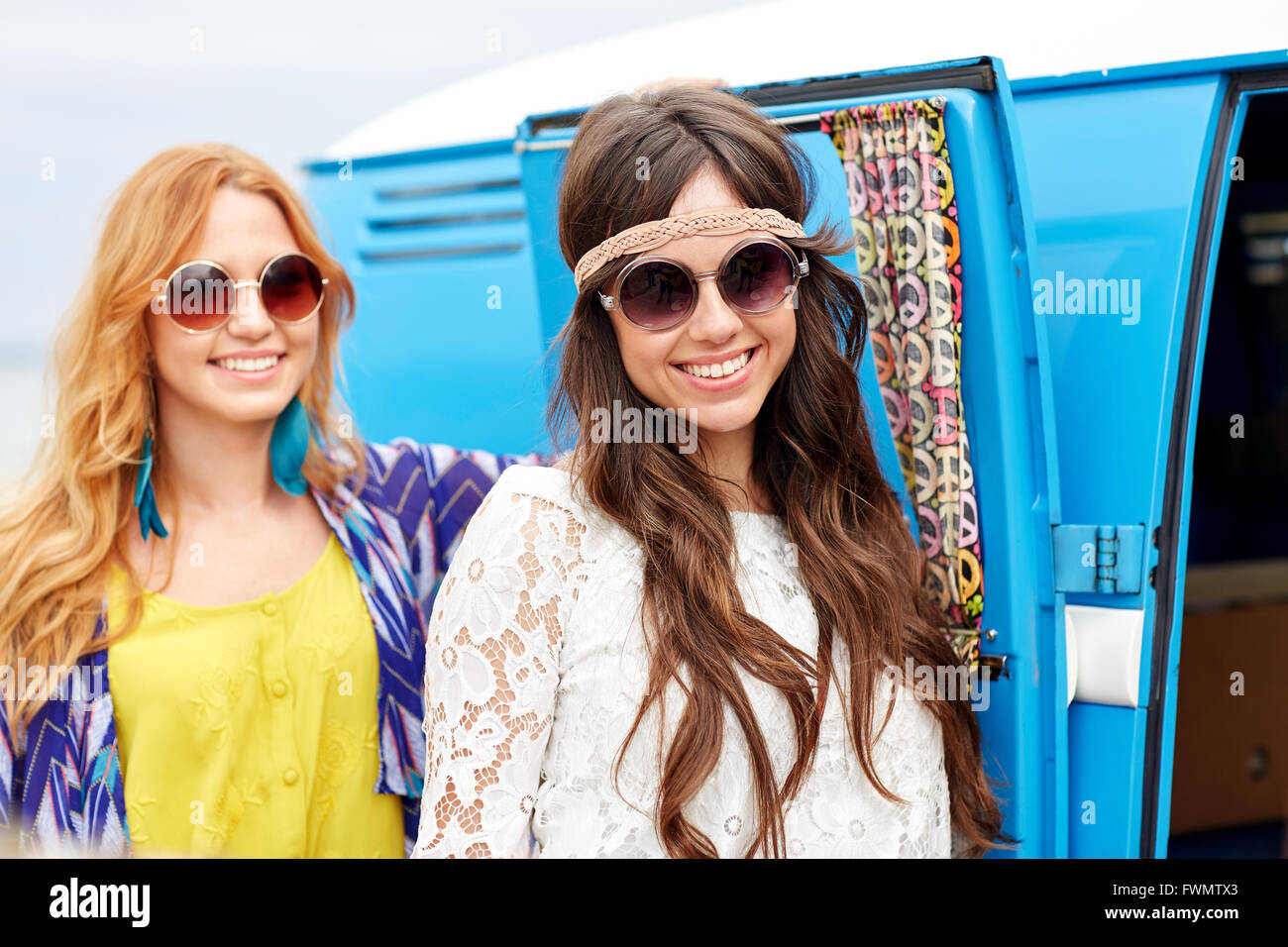 smiling young hippie women over minivan car Stock Photo - Alamy