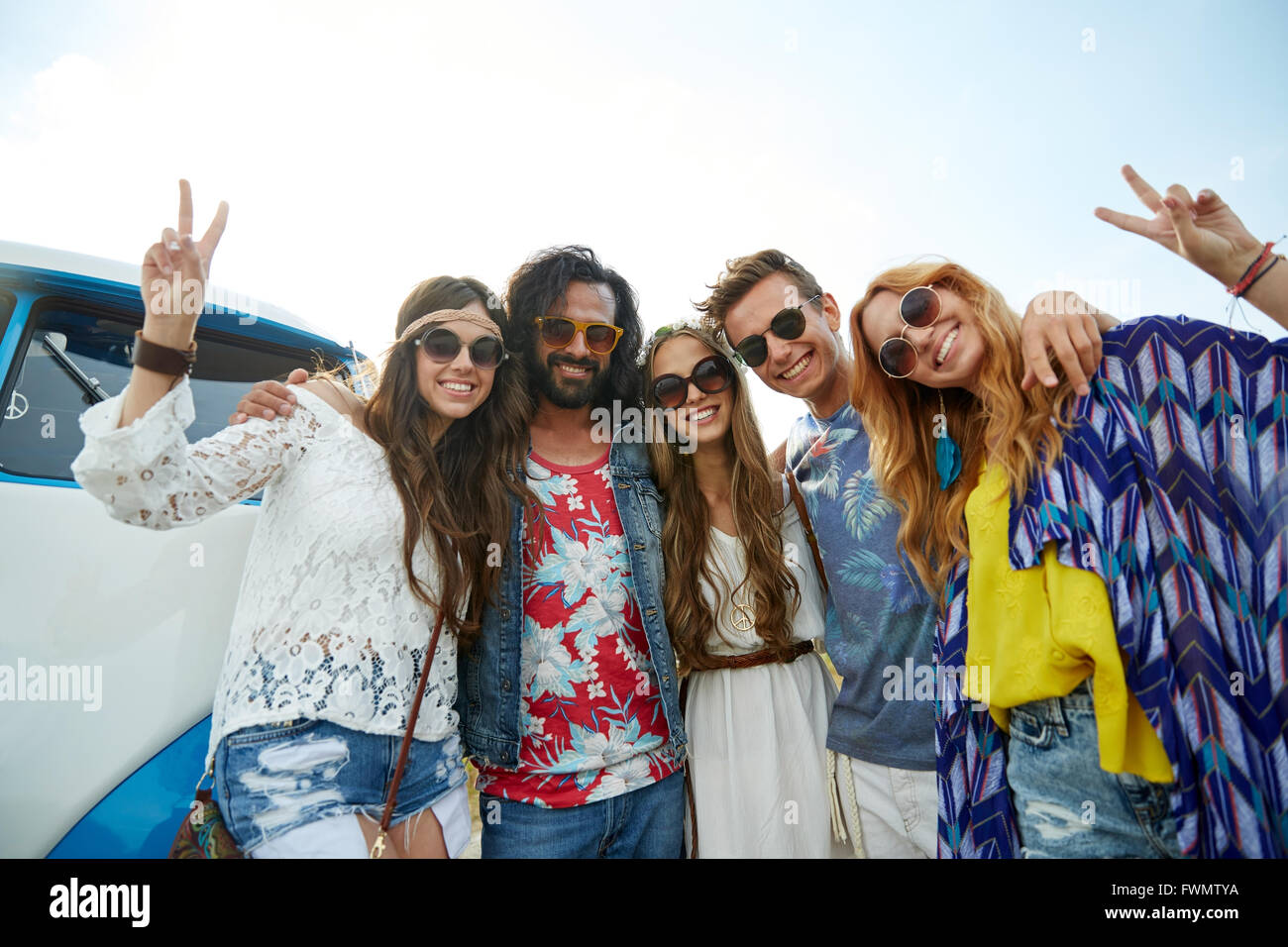 hippie friends over minivan car showing peace sign Stock Photo - Alamy