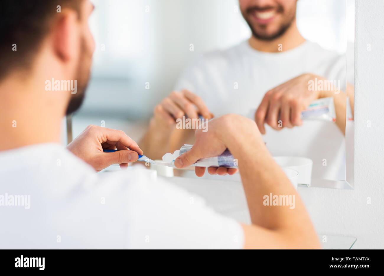 close up of man squeezing toothpaste on toothbrush Stock Photo - Alamy