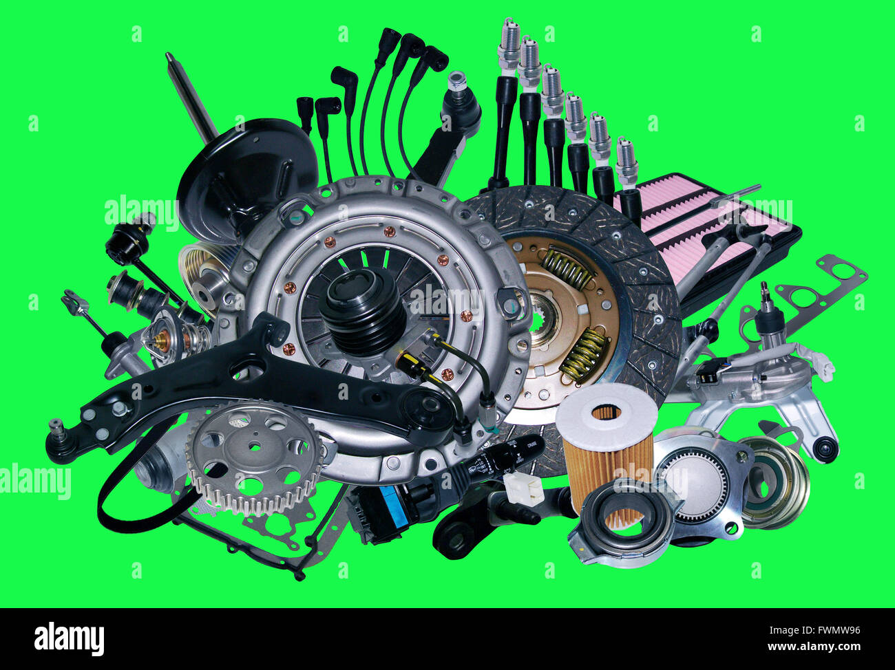 Many new spare parts for a car isolated on green background Stock Photo ...