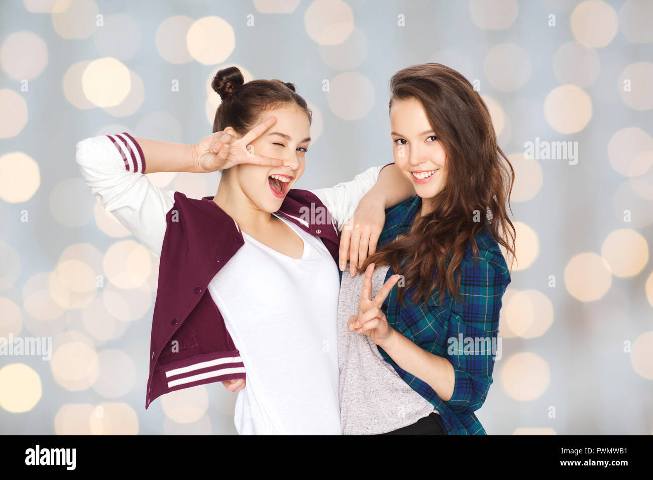 happy pretty teenage girls showing peace hand sign Stock Photo - Alamy