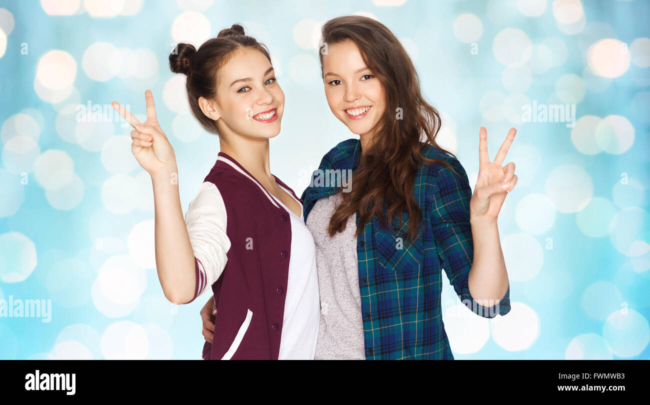 happy teenage girls hugging and showing peace sign Stock Photo - Alamy