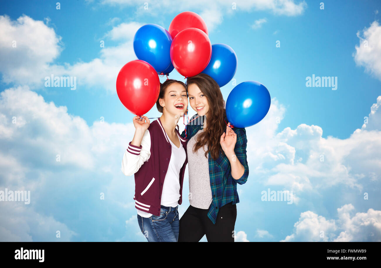 happy teenage girls with helium balloons over sky Stock Photo - Alamy
