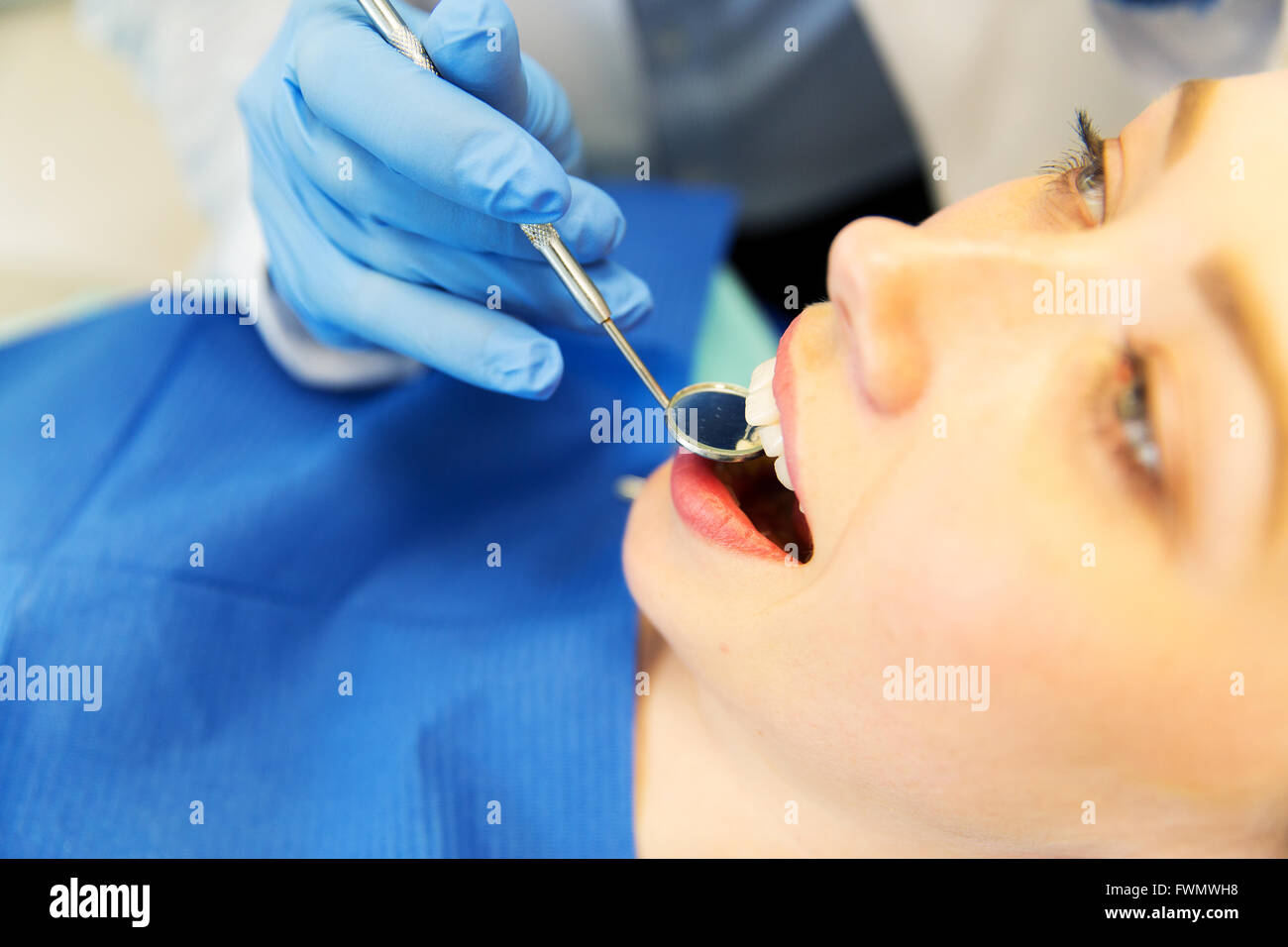 close up of dentist examining female patient teeth Stock Photo - Alamy