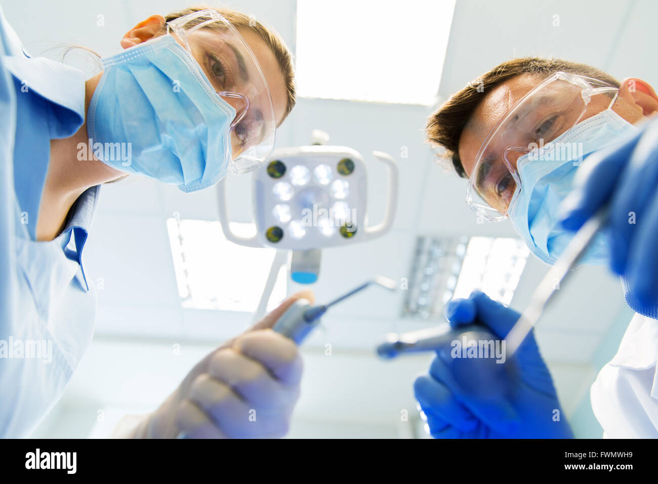 close up of dentist and assistant at dental clinic Stock Photo - Alamy