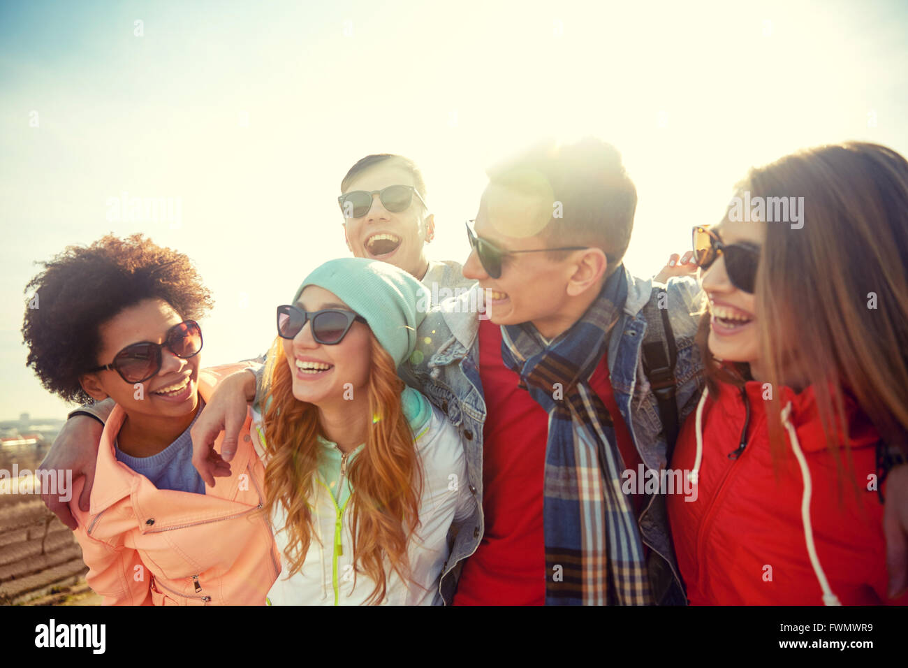 smiling friends in sunglasses laughing on street Stock Photo - Alamy