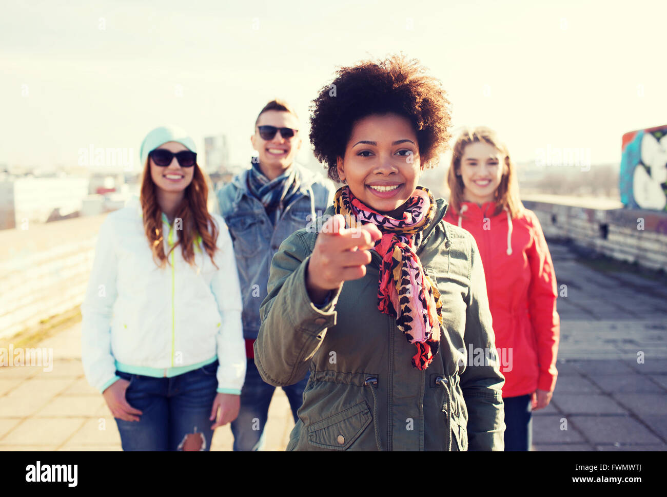 happy friends pointing finger to you on street Stock Photo - Alamy