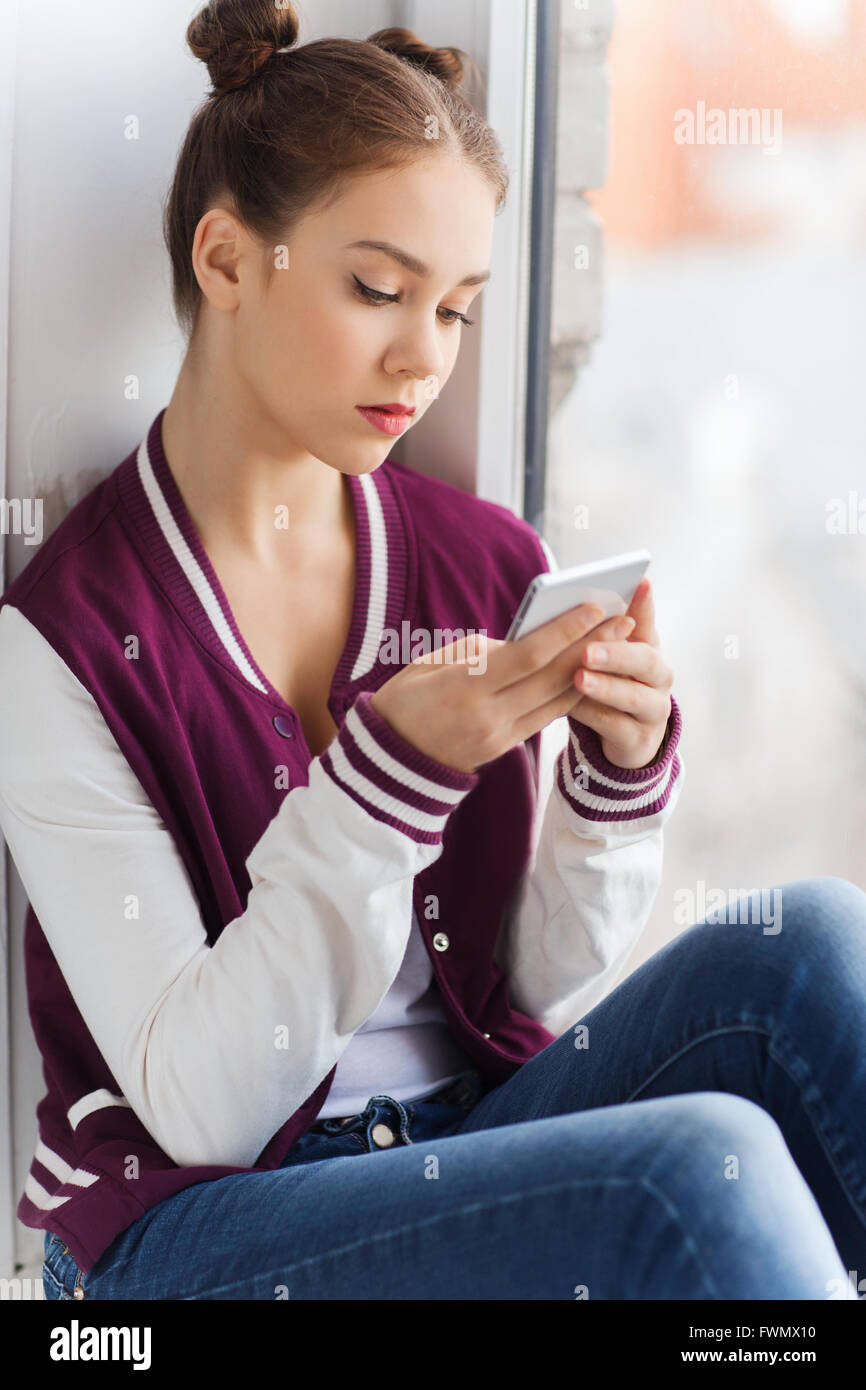 sad pretty teenage girl with smartphone texting Stock Photo - Alamy