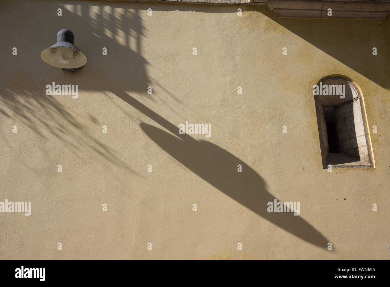 evening shadow casts a long shadow from a street lamp Stock Photo - Alamy