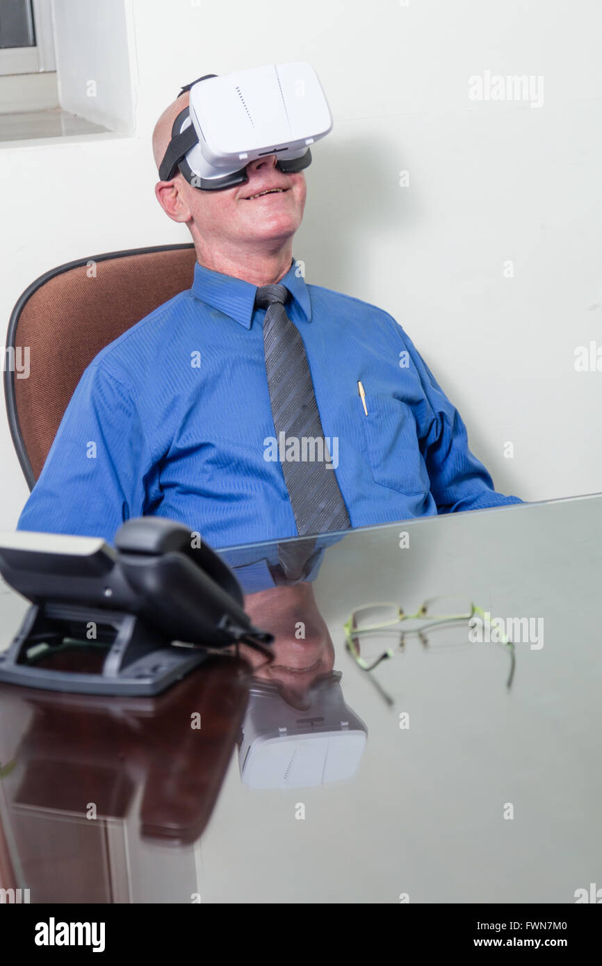 Smiling corporate executive wearing virtual reality headset Stock Photo ...