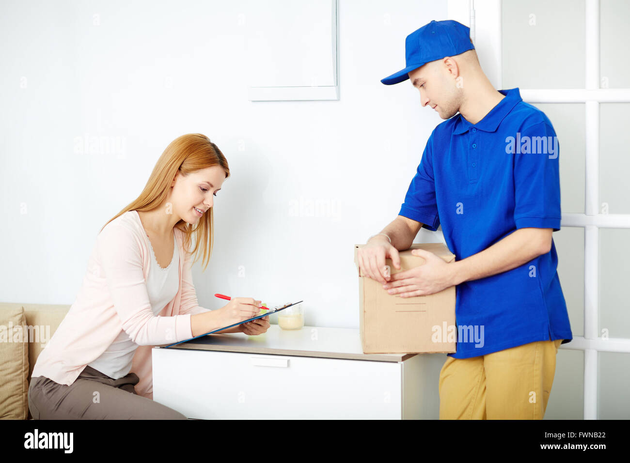 Signing for parcel Stock Photo - Alamy