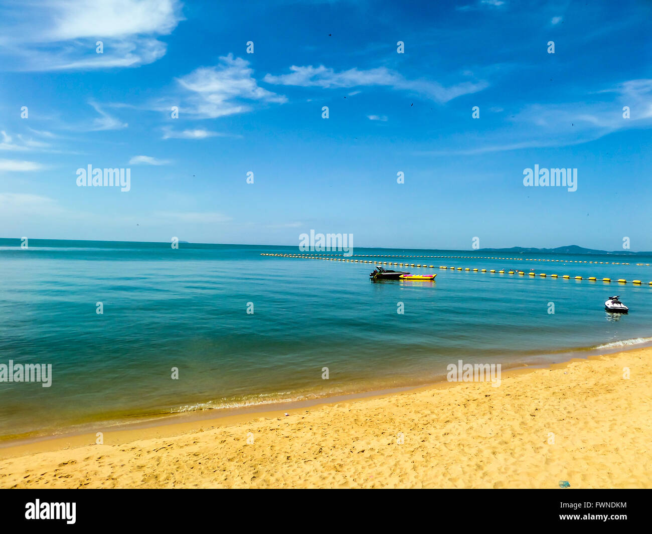 The boat and banana boat near barrier in the sea and blue sky Stock ...