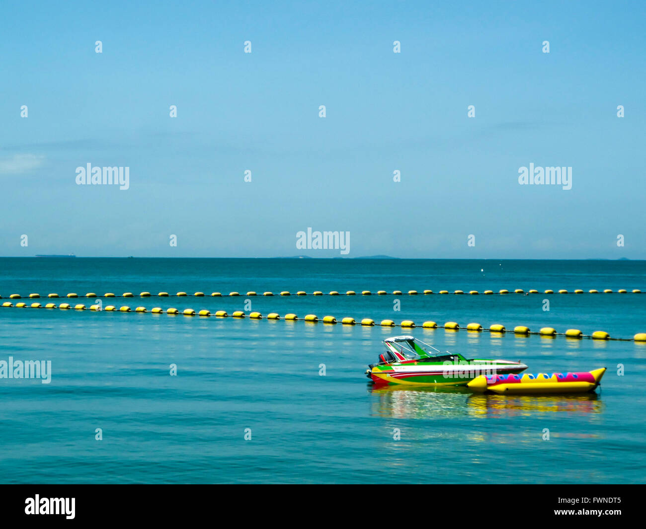 The boat and banana boat near barrier in the sea and blue sky Stock ...
