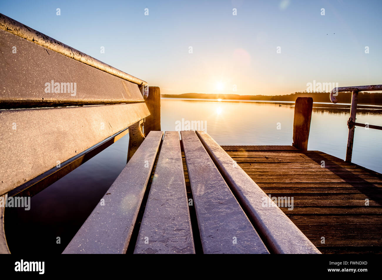 A bench during sunrise over the Kellersee in Malente, Germany Stock ...