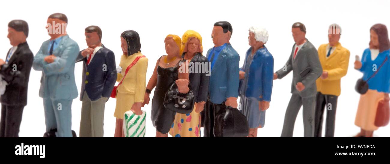 Miniature figure people forming an orderly queue against a white ...