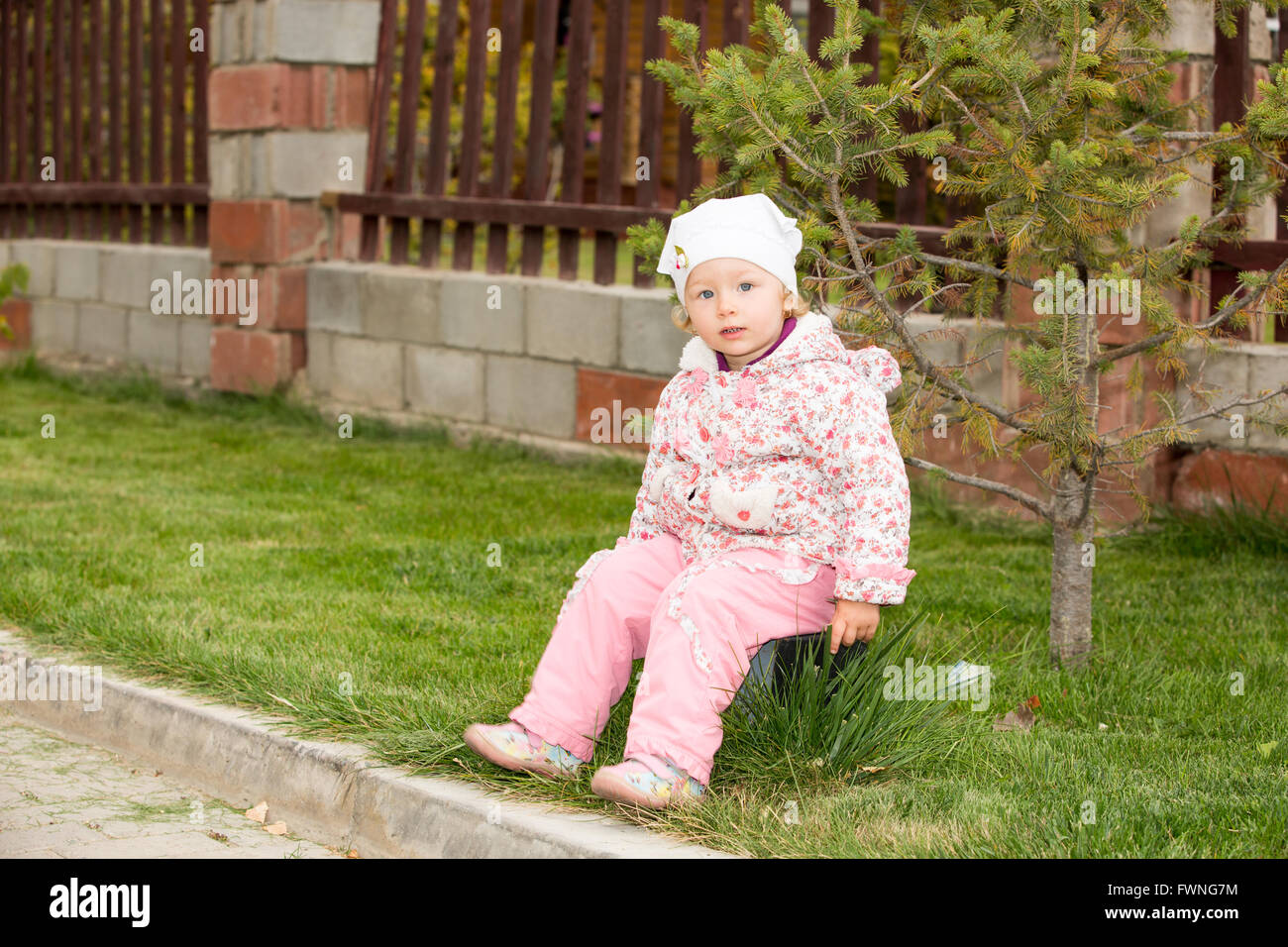 Adorable little child girl. Summer green nature background. Use it for ...