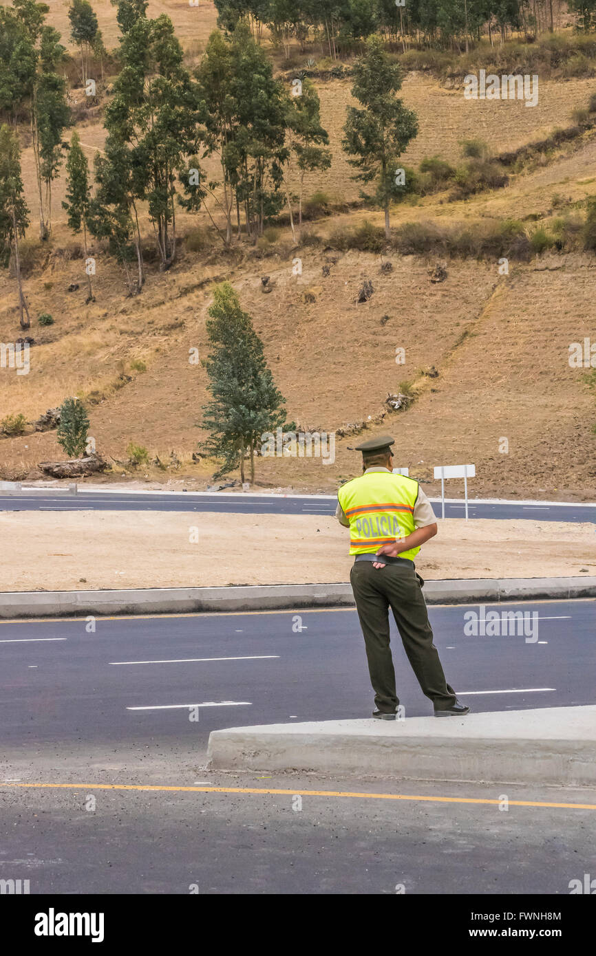 QUITO, ECUADOR, OCTOBER - 2015 - Back view of traffic policeman on the ...